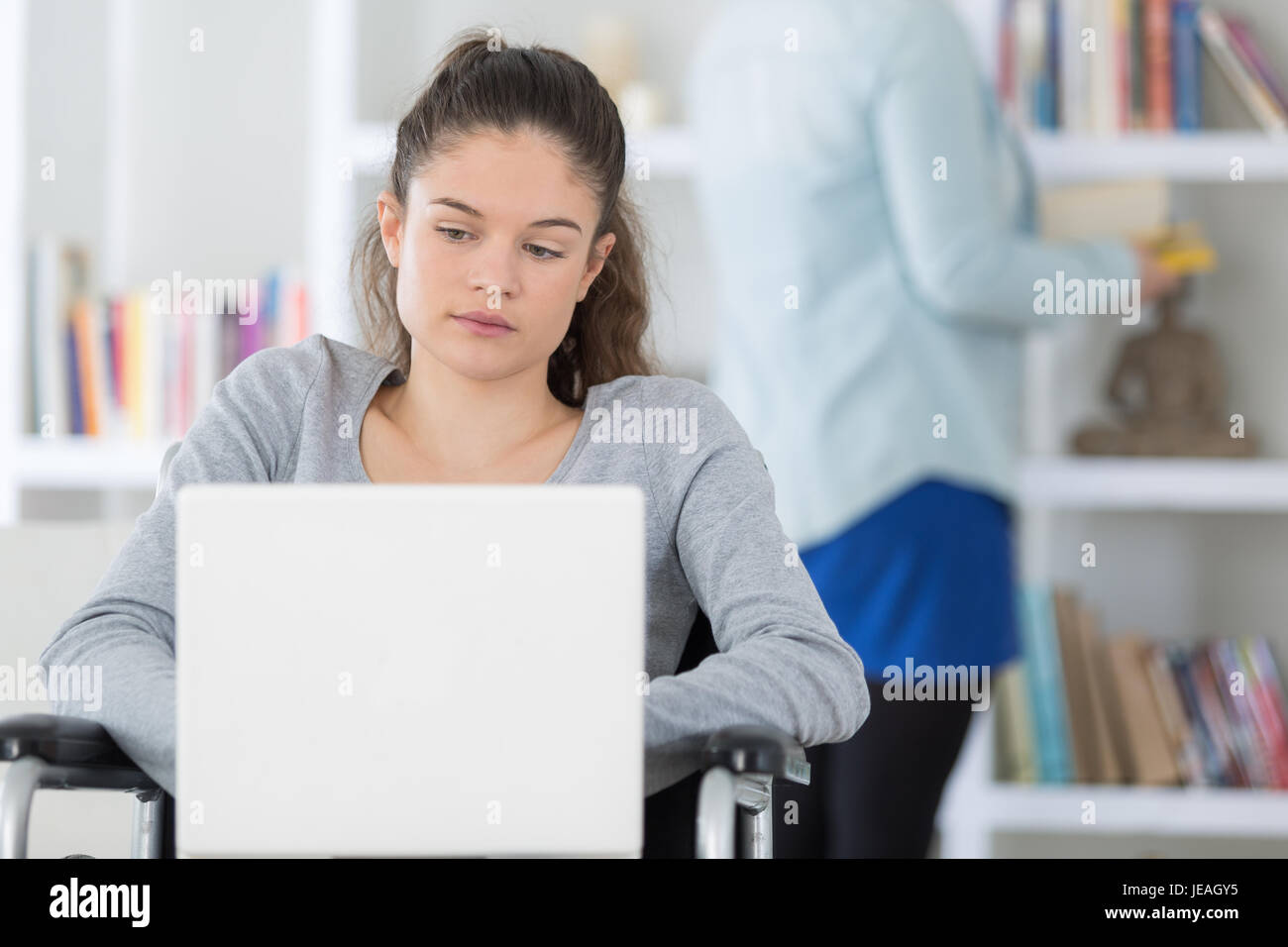 Disabled adolescent using computer Stock Photo - Alamy