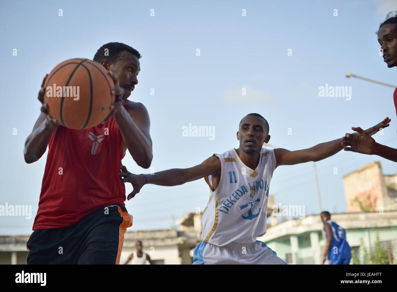 This image shows a basketball game in Mogadishu, Somalia. The game ...