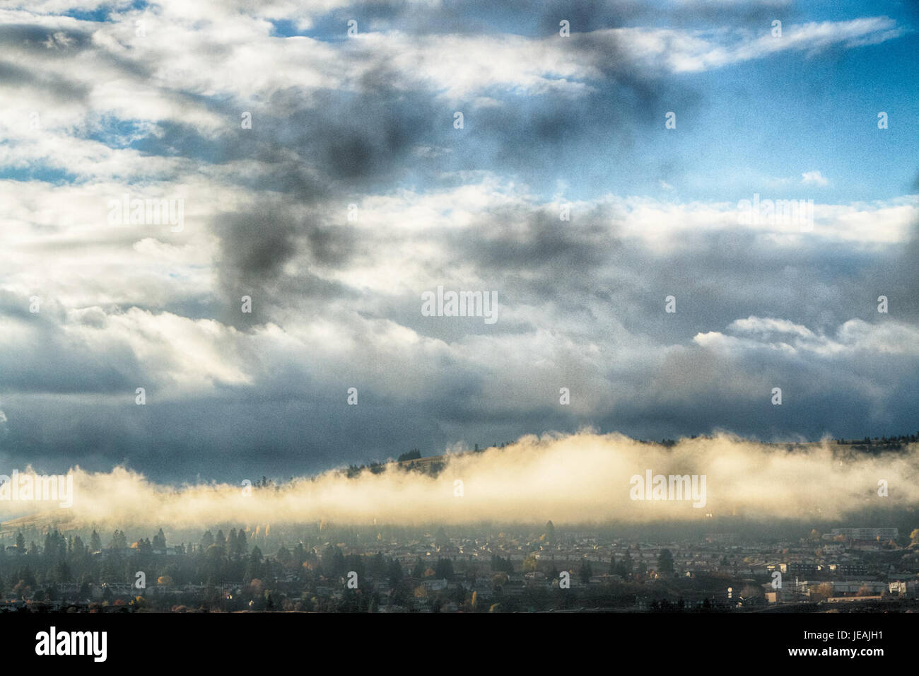 ‘City Clouds’ depicts a cityscape with dramatic cloud formations ...