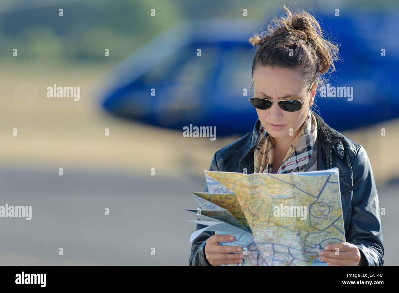 woman looking at map while waiting for husband Stock Photo - Alamy