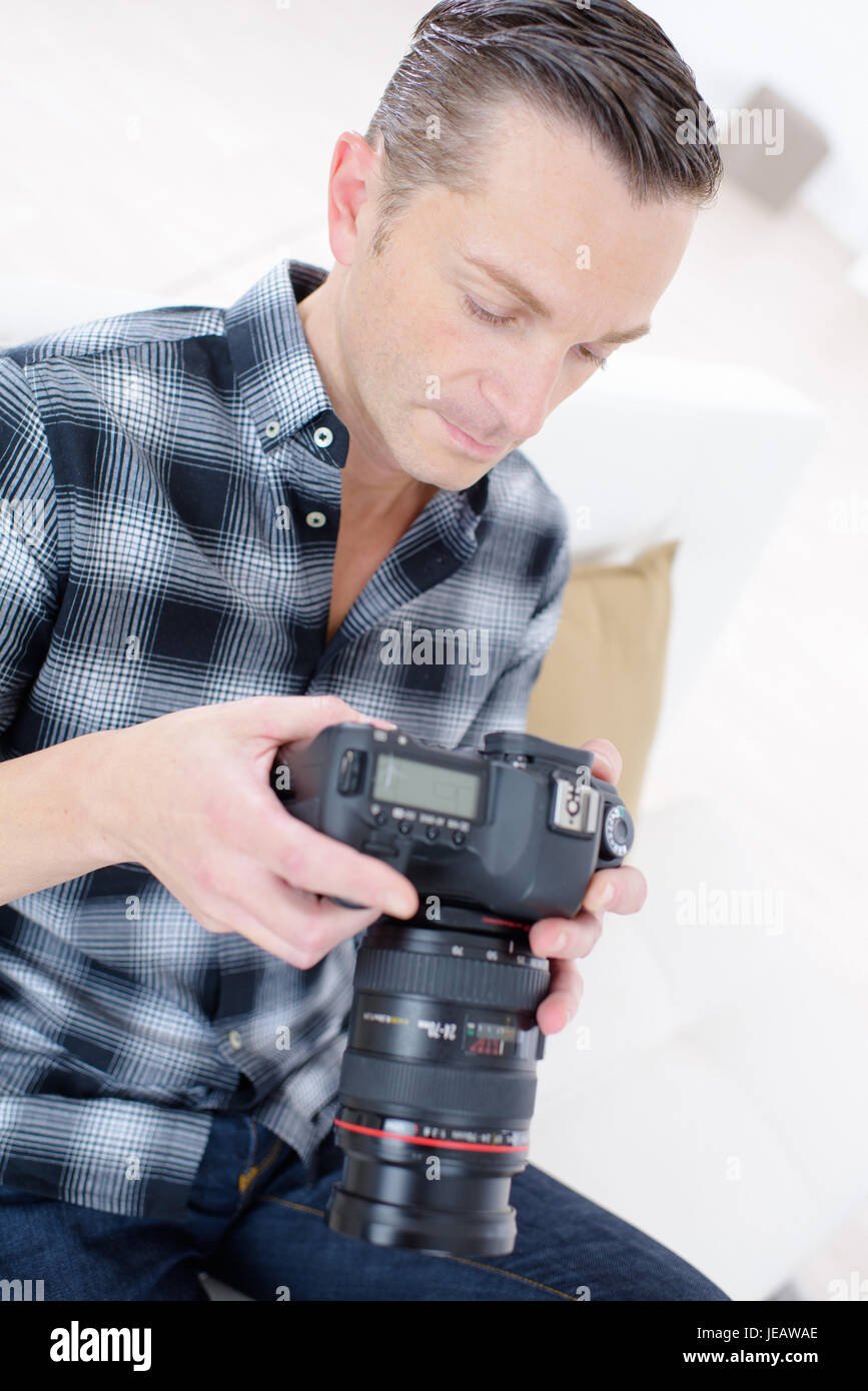 male photographer checking photos in his camera Stock Photo - Alamy