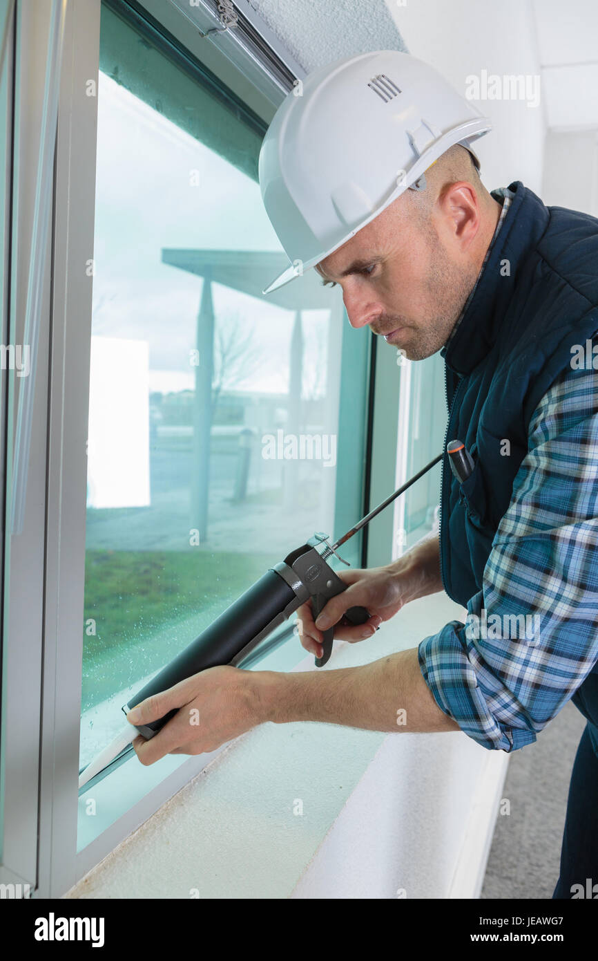 construction worker installing window in house Stock Photo - Alamy
