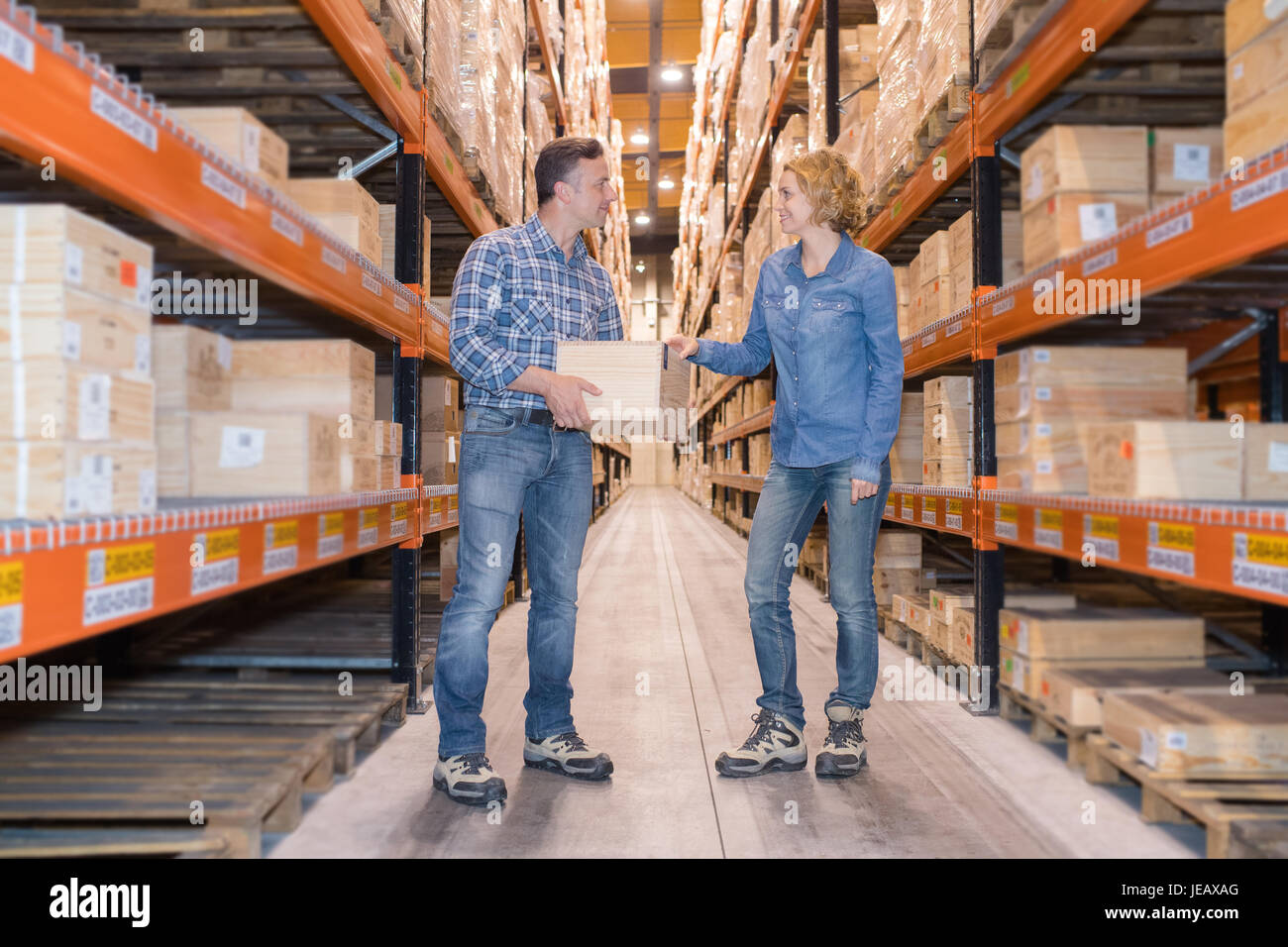 standing workers in warehouse checking invoice Stock Photo - Alamy