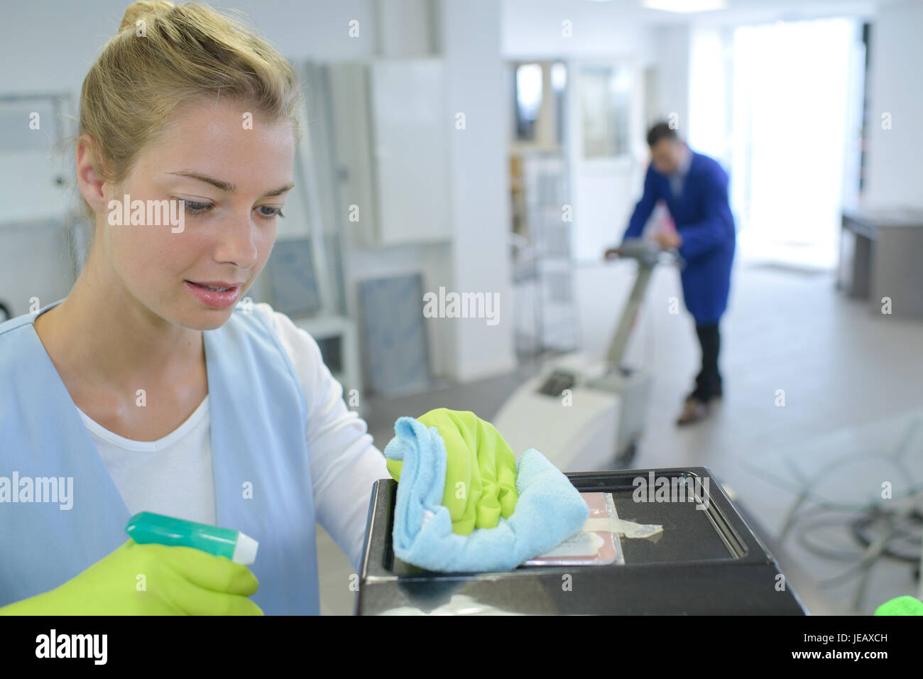 female cleaner cleaning corridor of business building Stock Photo - Alamy
