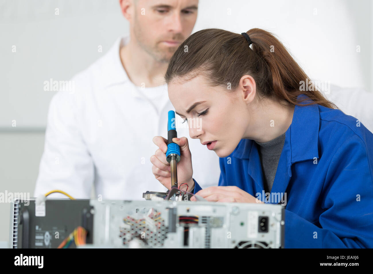 Female technician using soldering hi-res stock photography and images ...