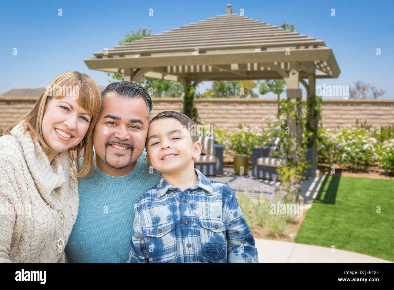 Mixed Race Family In Back Yard Near Patio Cover Stock Photo - Alamy