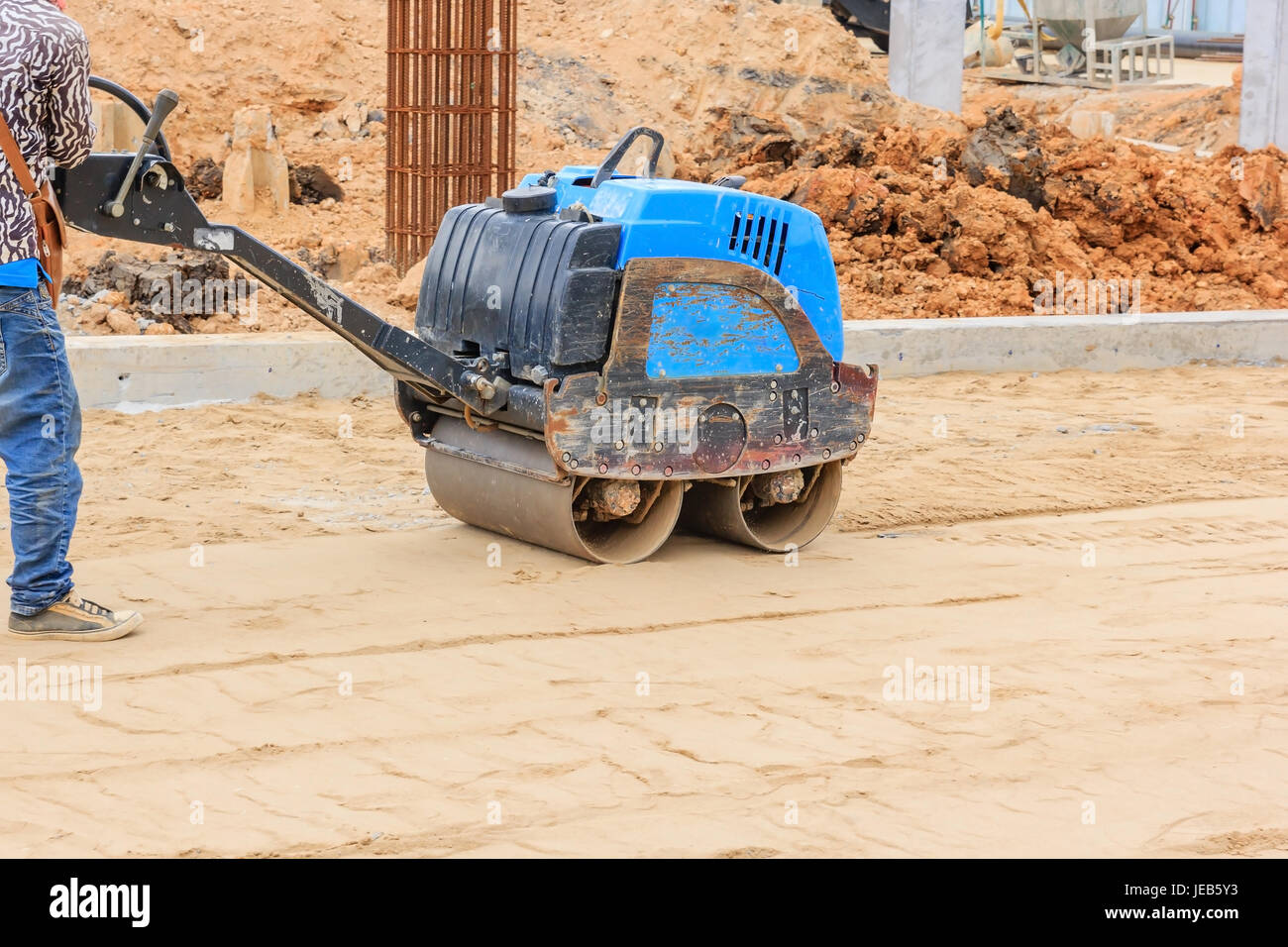 Construction workers during road roller at work on the road ...