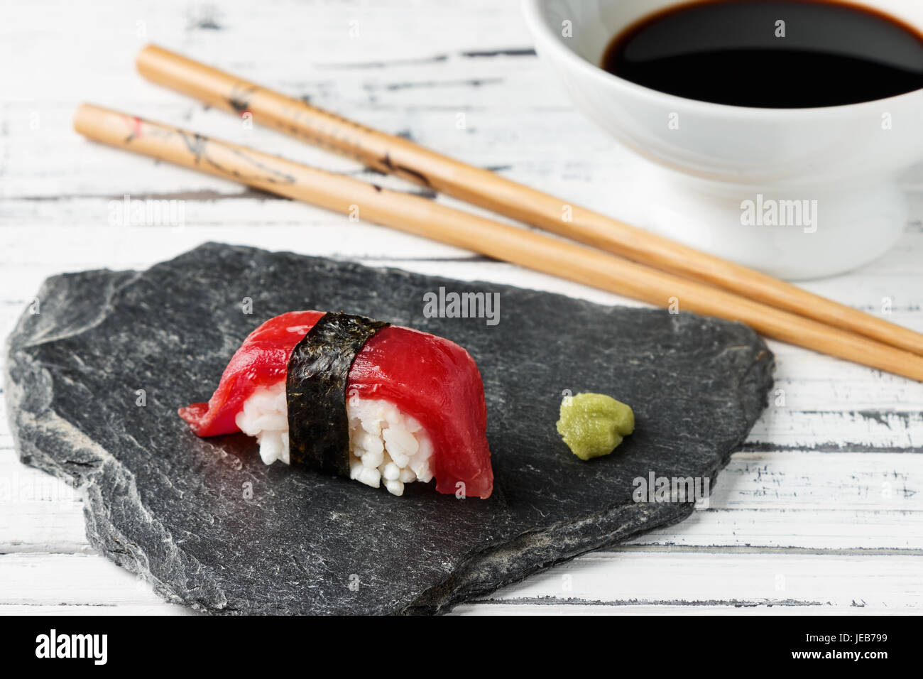 Red tuna Nigiri with Nori seaweed and wasabi paste on slate stone ...