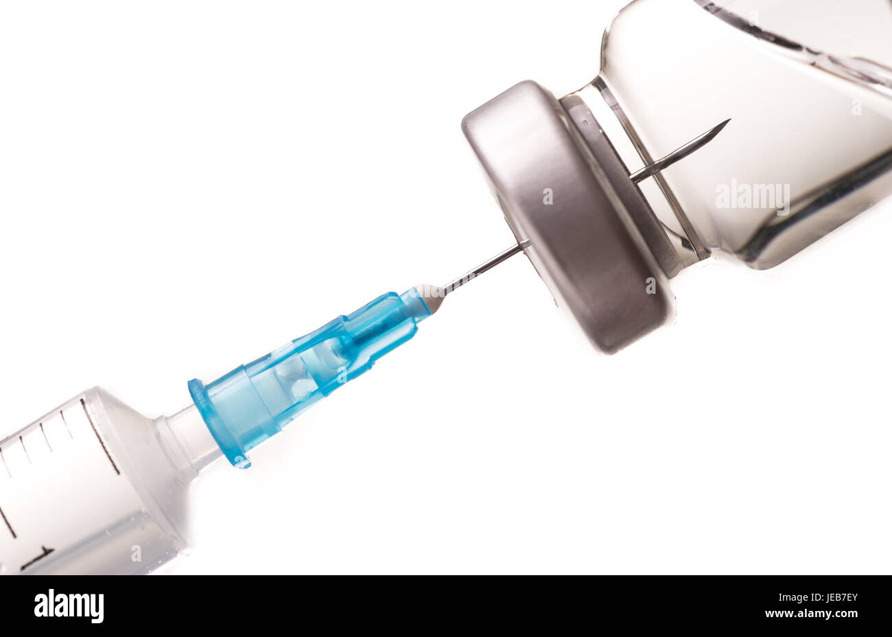 Syringe, needle and medicine vial. The needle sticks through the ...