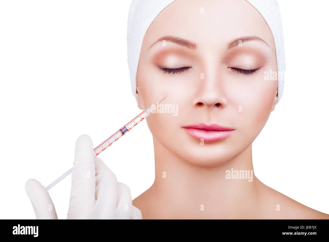 Beautiful woman gets an injection in her face isolated on white ...