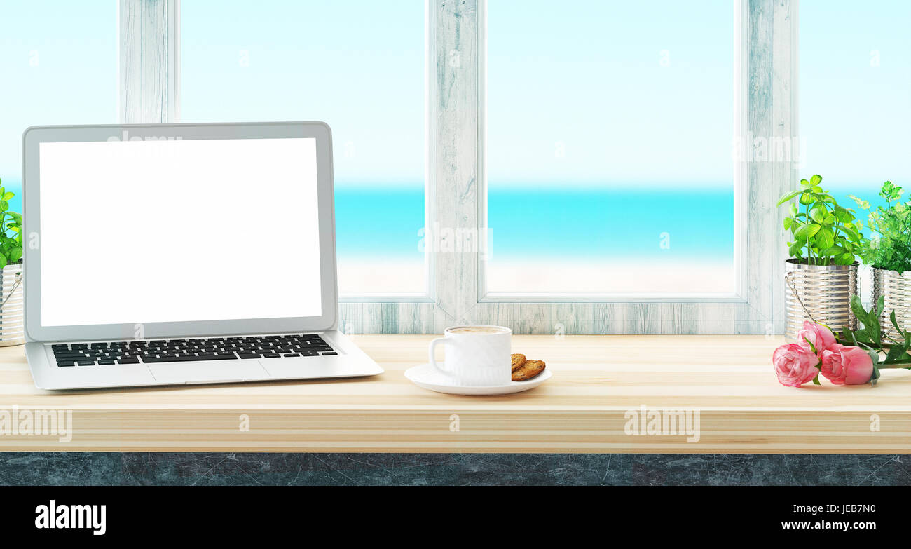Computer on desk with sea view Stock Photo - Alamy
