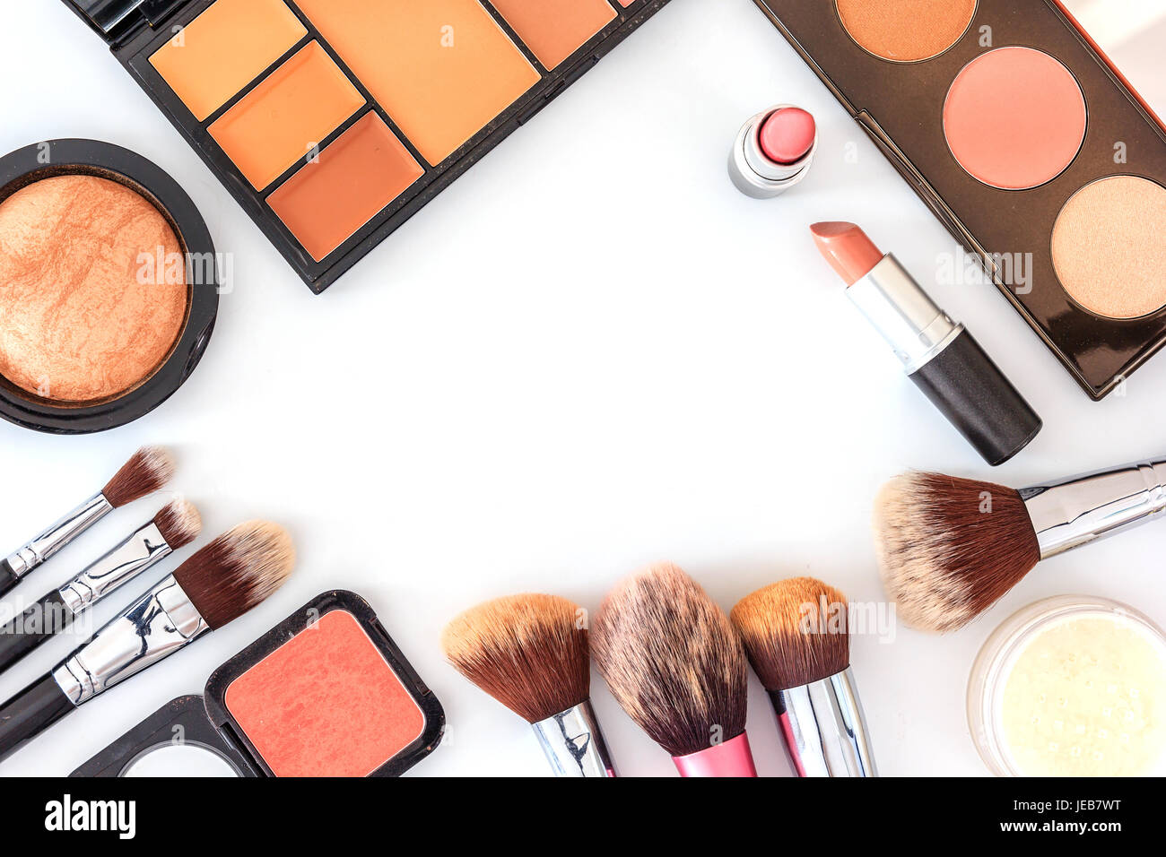 A collection of brush, make up and cosmetic beauty products arranged on ...