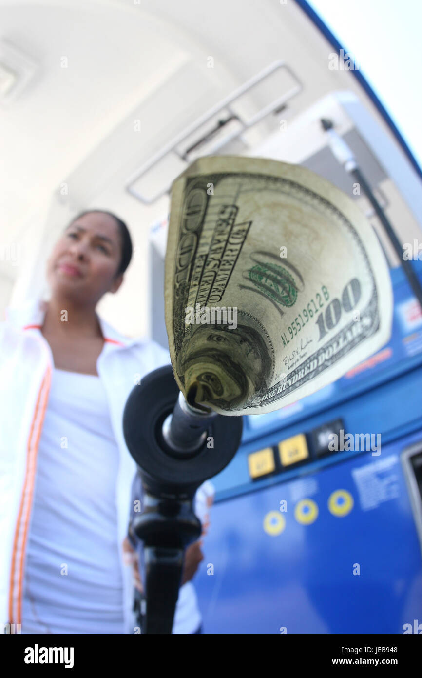 Putting money into gas tank Stock Photo - Alamy