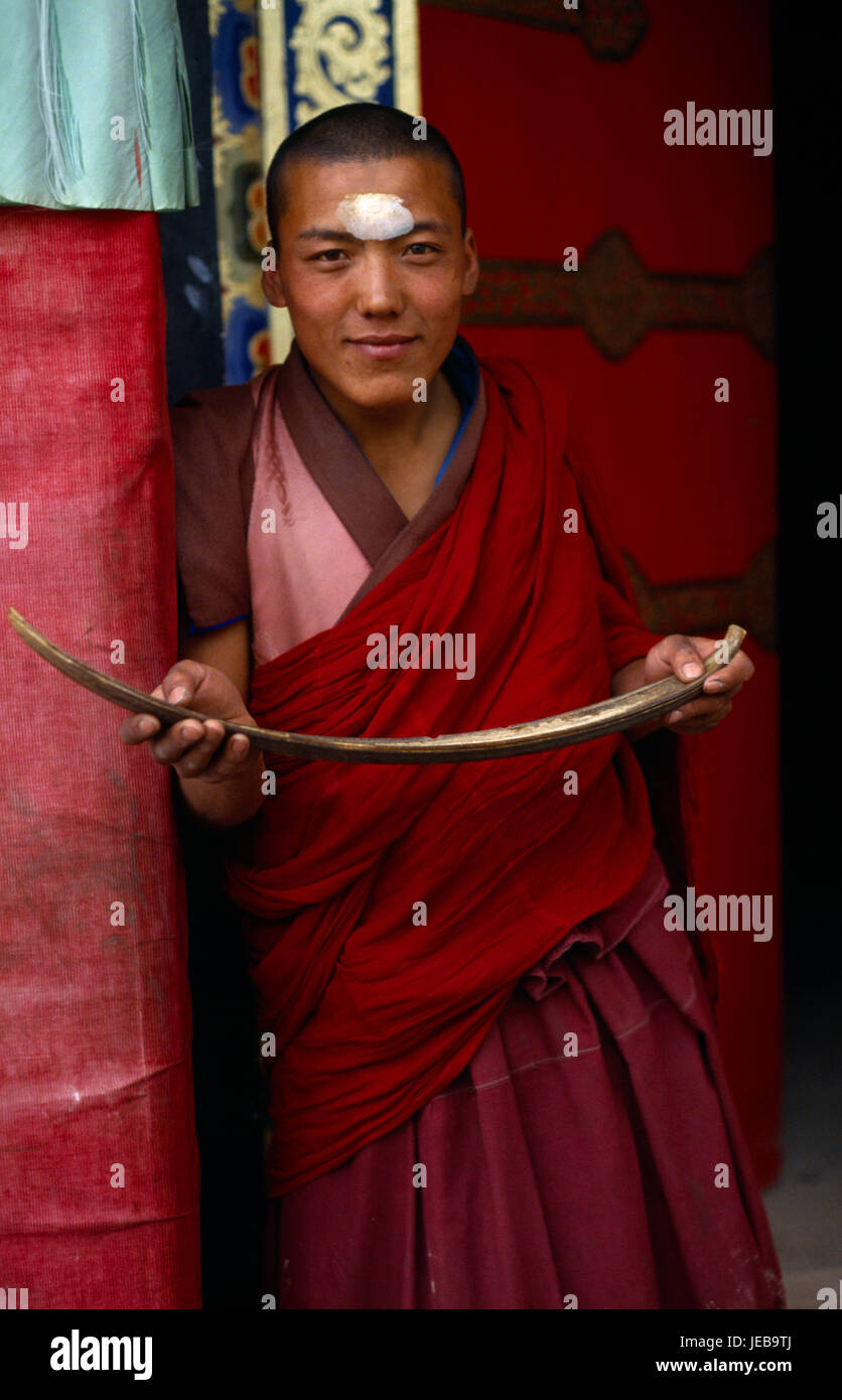 China, Gansu Province, Xiahe, Labrang Monastery. Young monk three ...