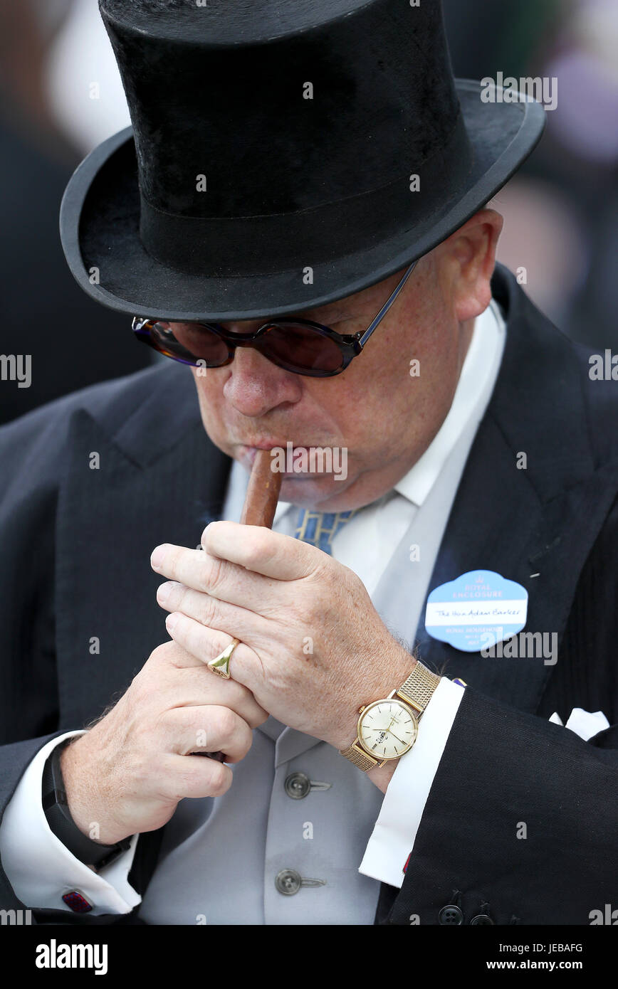 A racegoer lights a cigar during day four of Royal Ascot at Ascot ...
