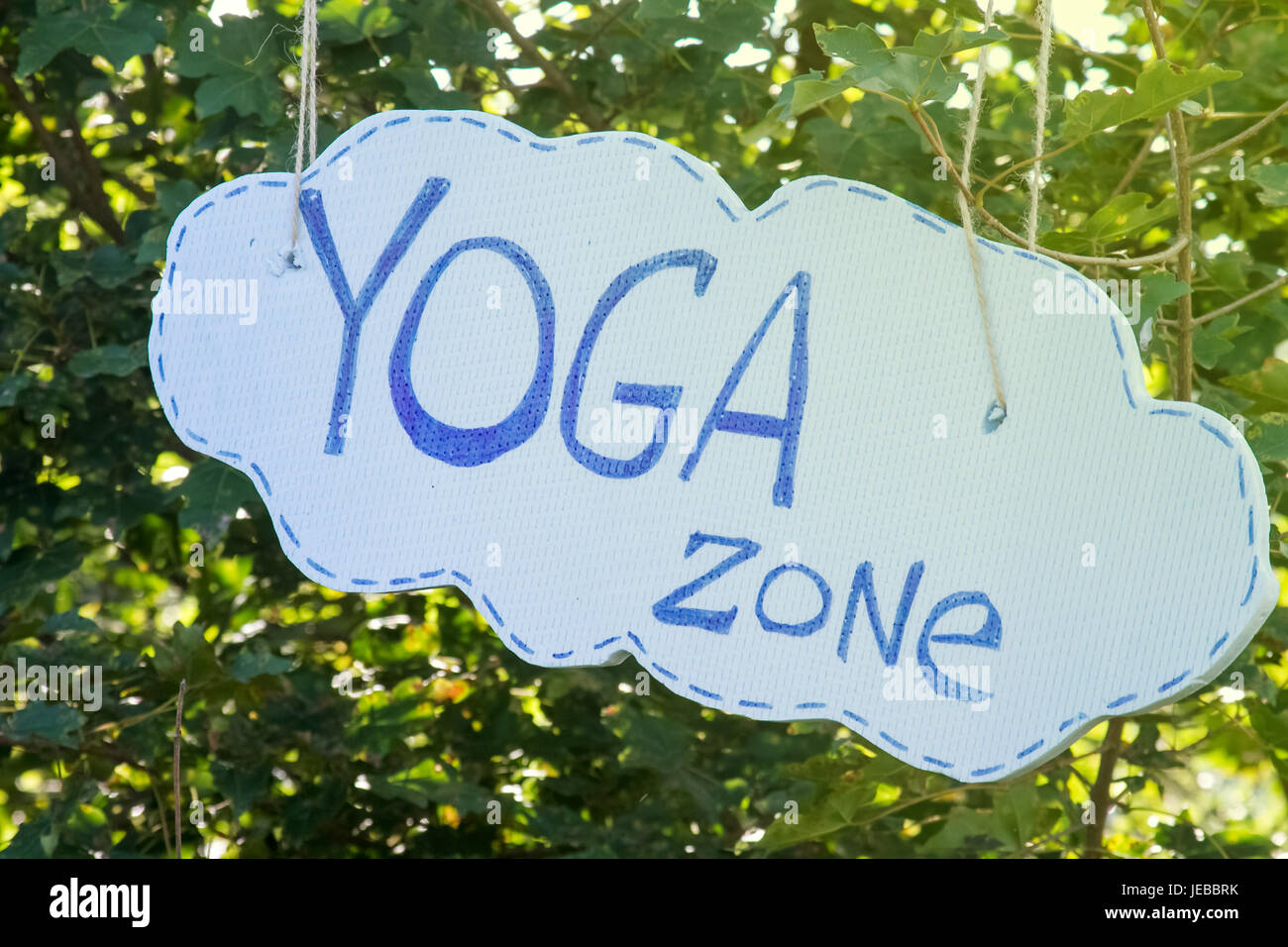 Inscription Yoga Zone on a background of green tree leaves Stock Photo ...