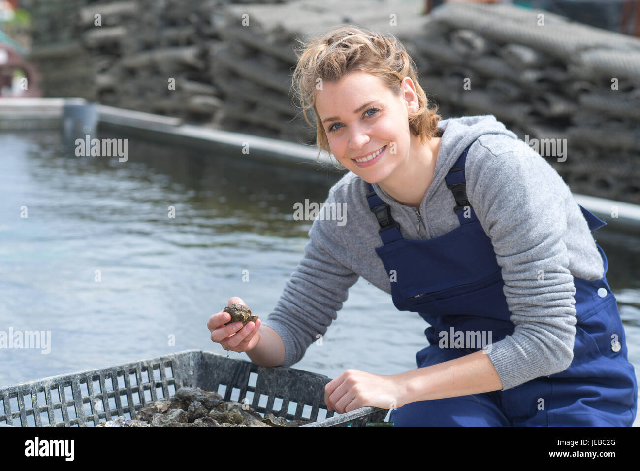 happy femake worker at fish and mussel farm Stock Photo - Alamy