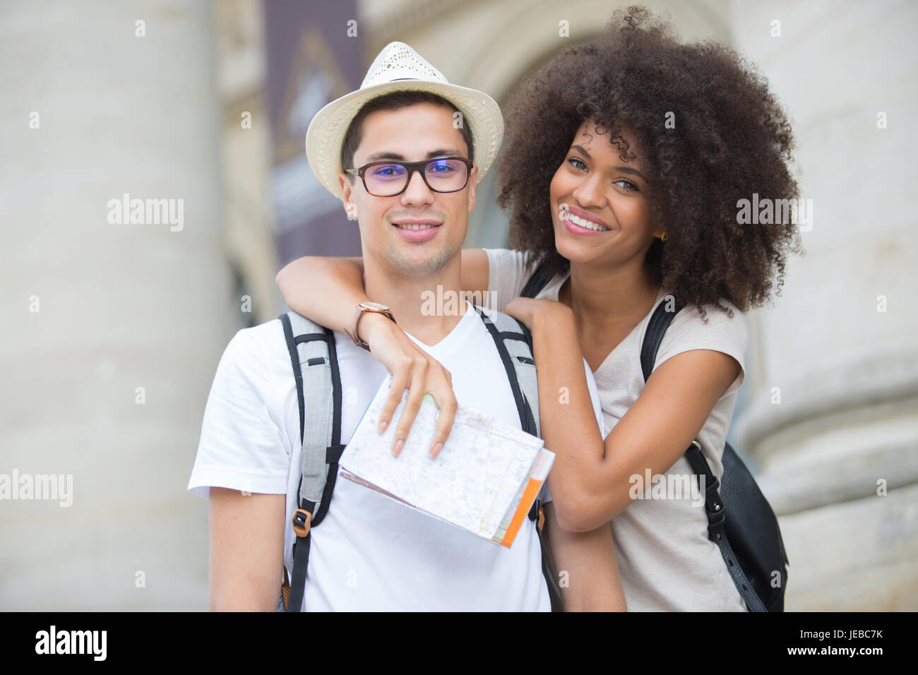 happy tourists with map sightseeing city Stock Photo - Alamy