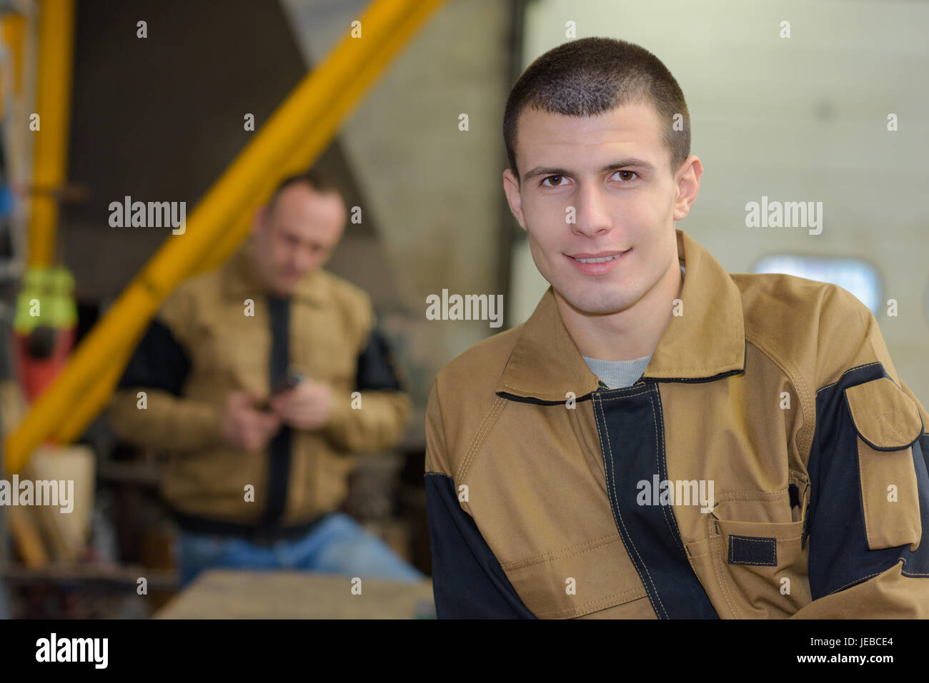 young handsome factory worker during work Stock Photo - Alamy