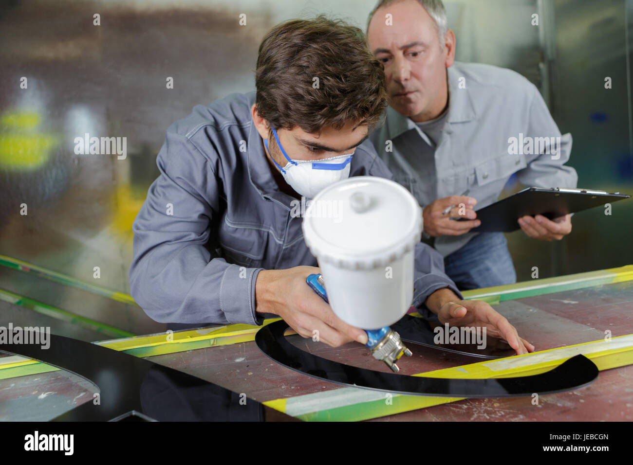 worker and apprentice learning to spray painting Stock Photo - Alamy
