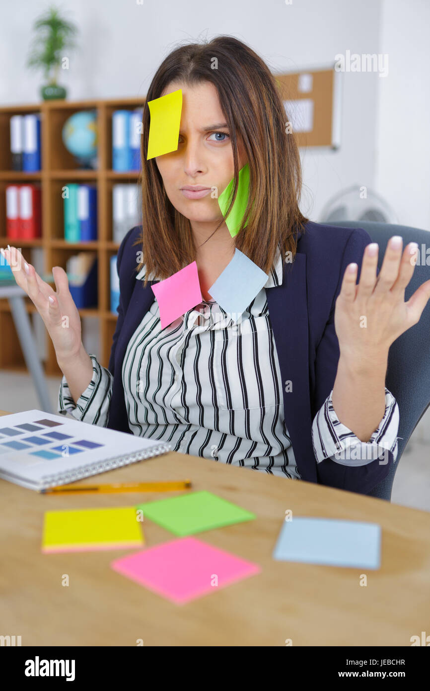 attractive businesswoman at office with post it on her forehead Stock ...