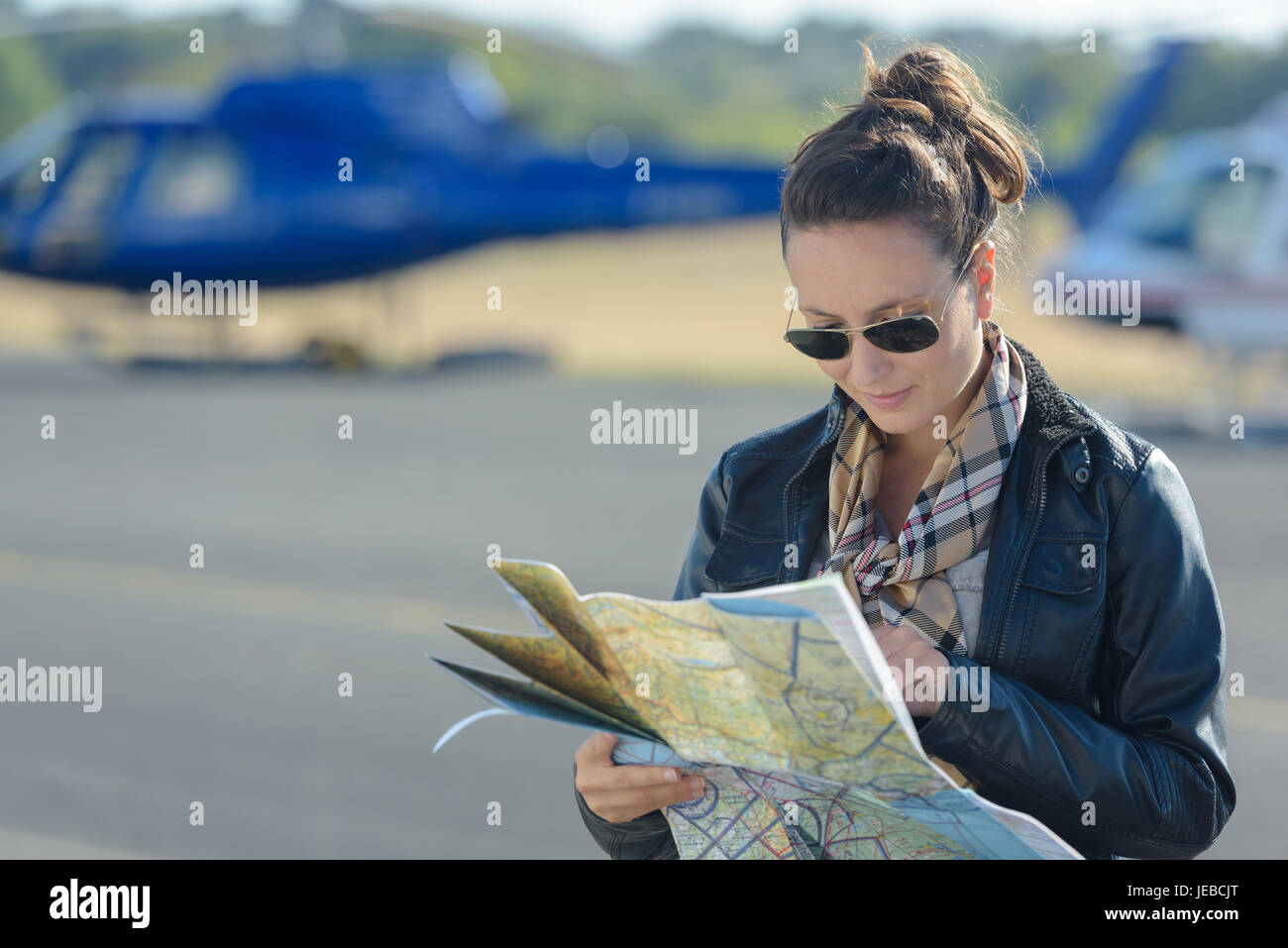 female pilot looking at the map Stock Photo - Alamy