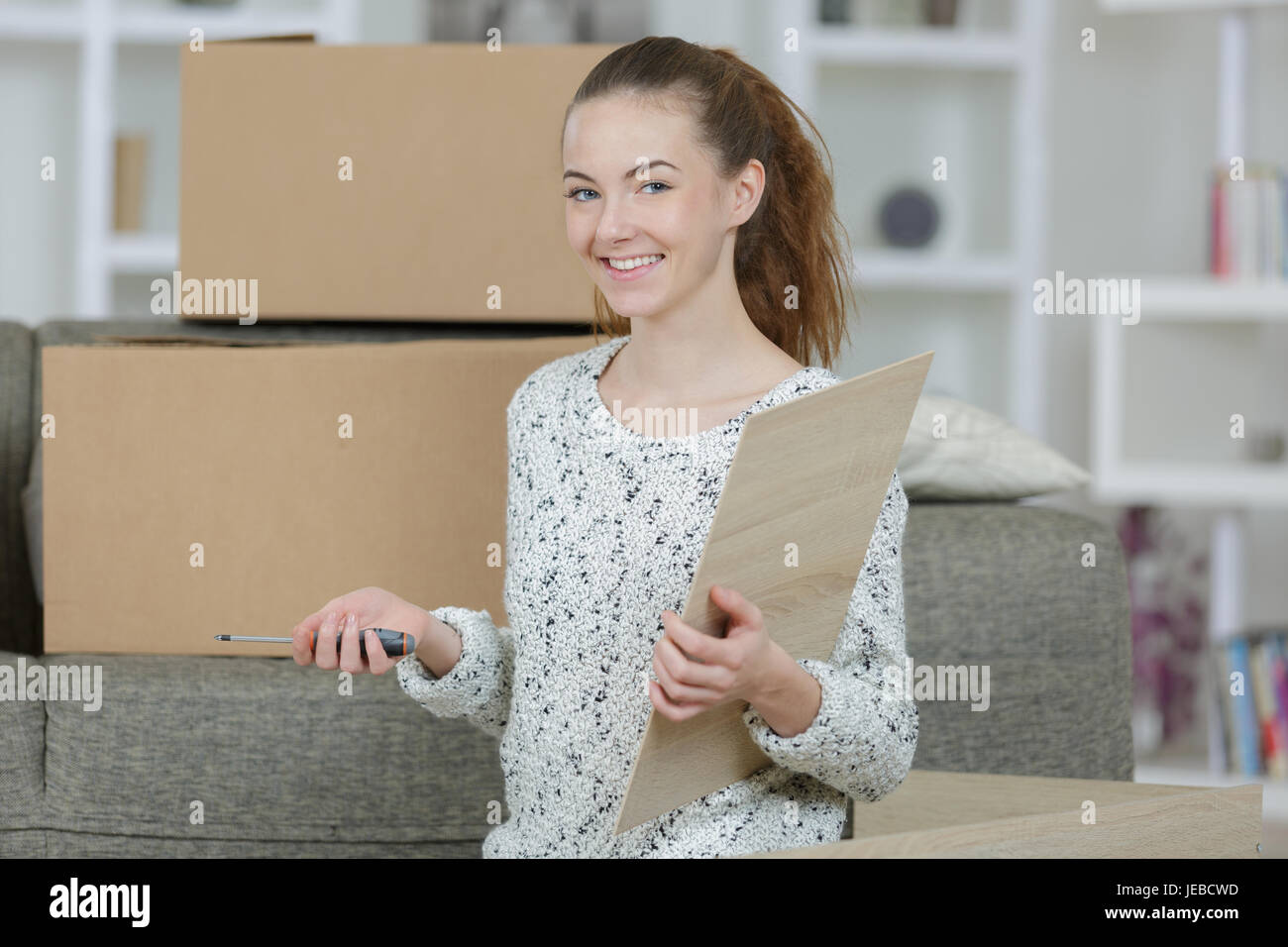 happy female moving house Stock Photo - Alamy