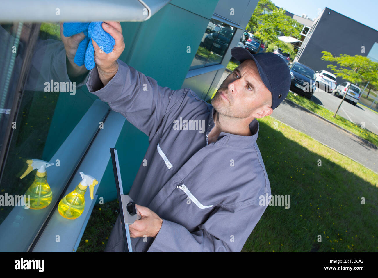 window cleaning employee with work tools Stock Photo - Alamy
