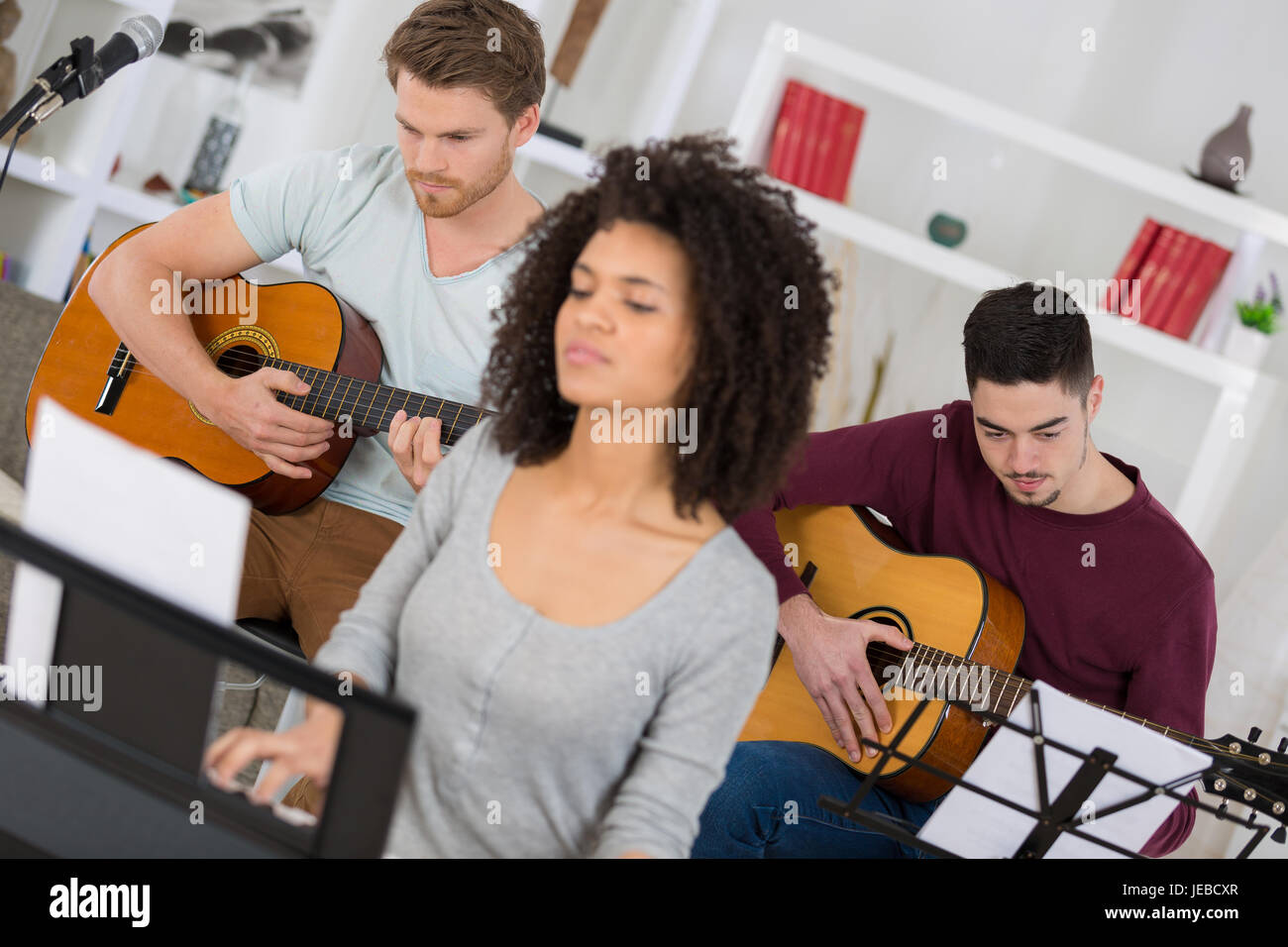 group of young friends playing the guitar Stock Photo - Alamy