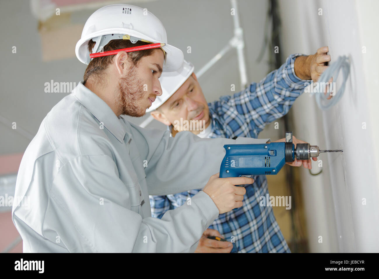 craftsman watching over his apprentice Stock Photo - Alamy