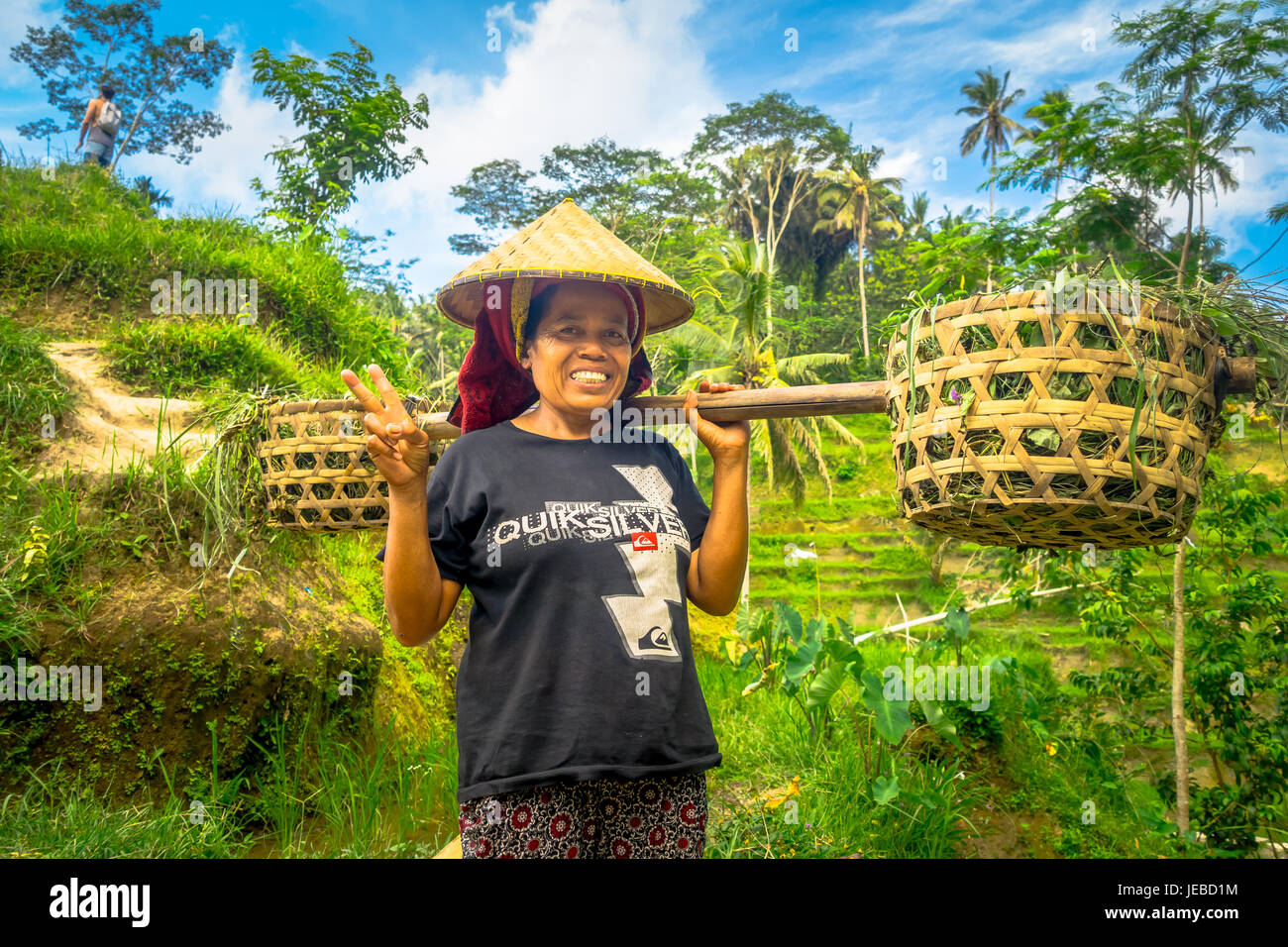 BALI, INDONESIA - APRIL 05, 2017: Women walk in the rice fields wearing ...
