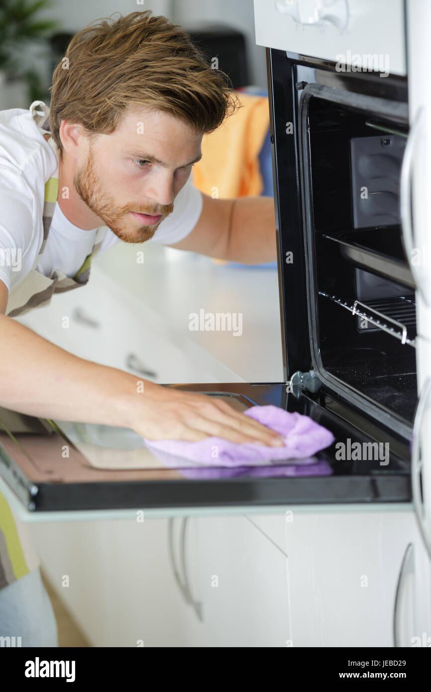 man cleaning oven Stock Photo - Alamy