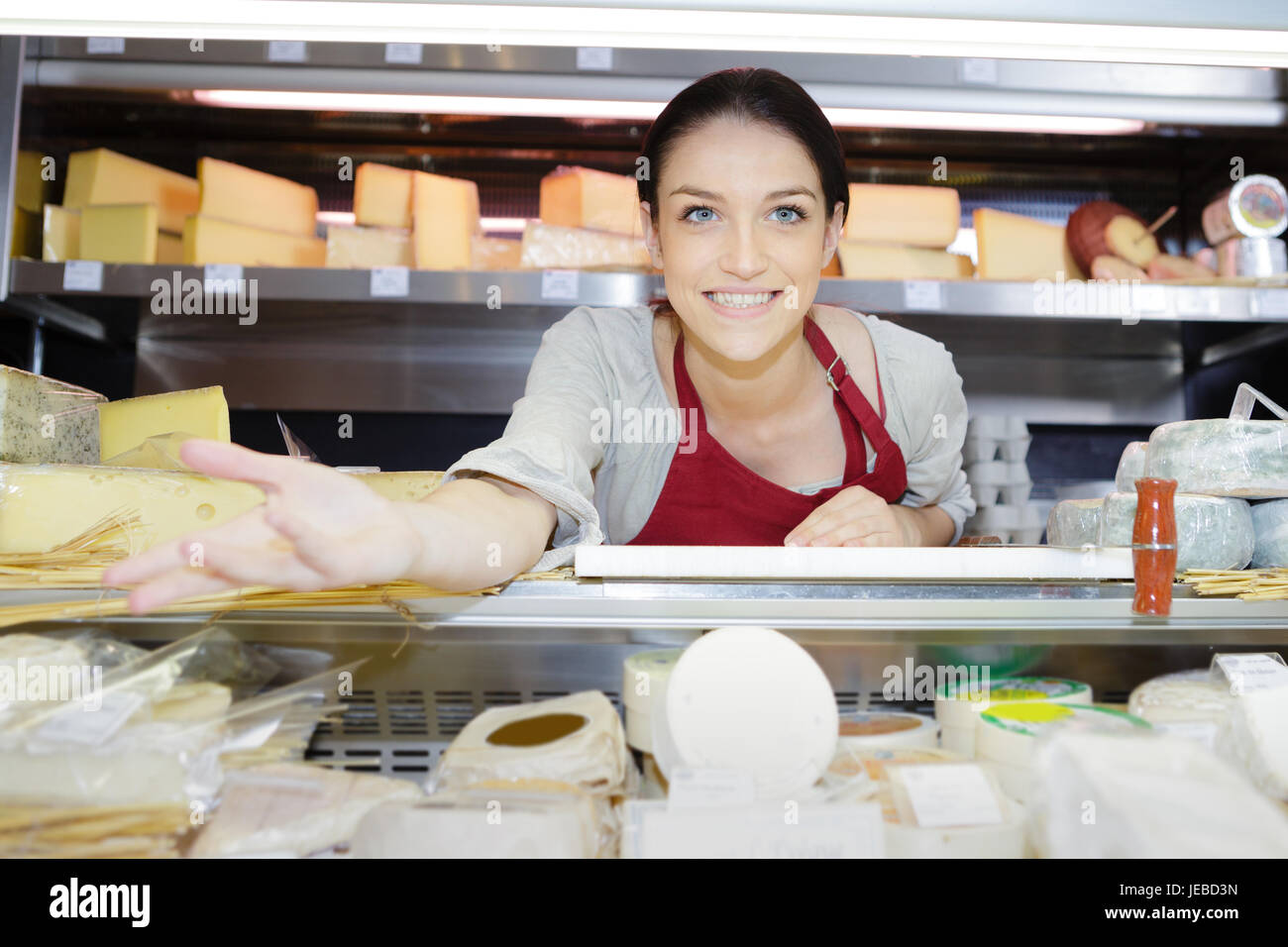 beautiful female brunette with different types of cheese in gastronomy ...