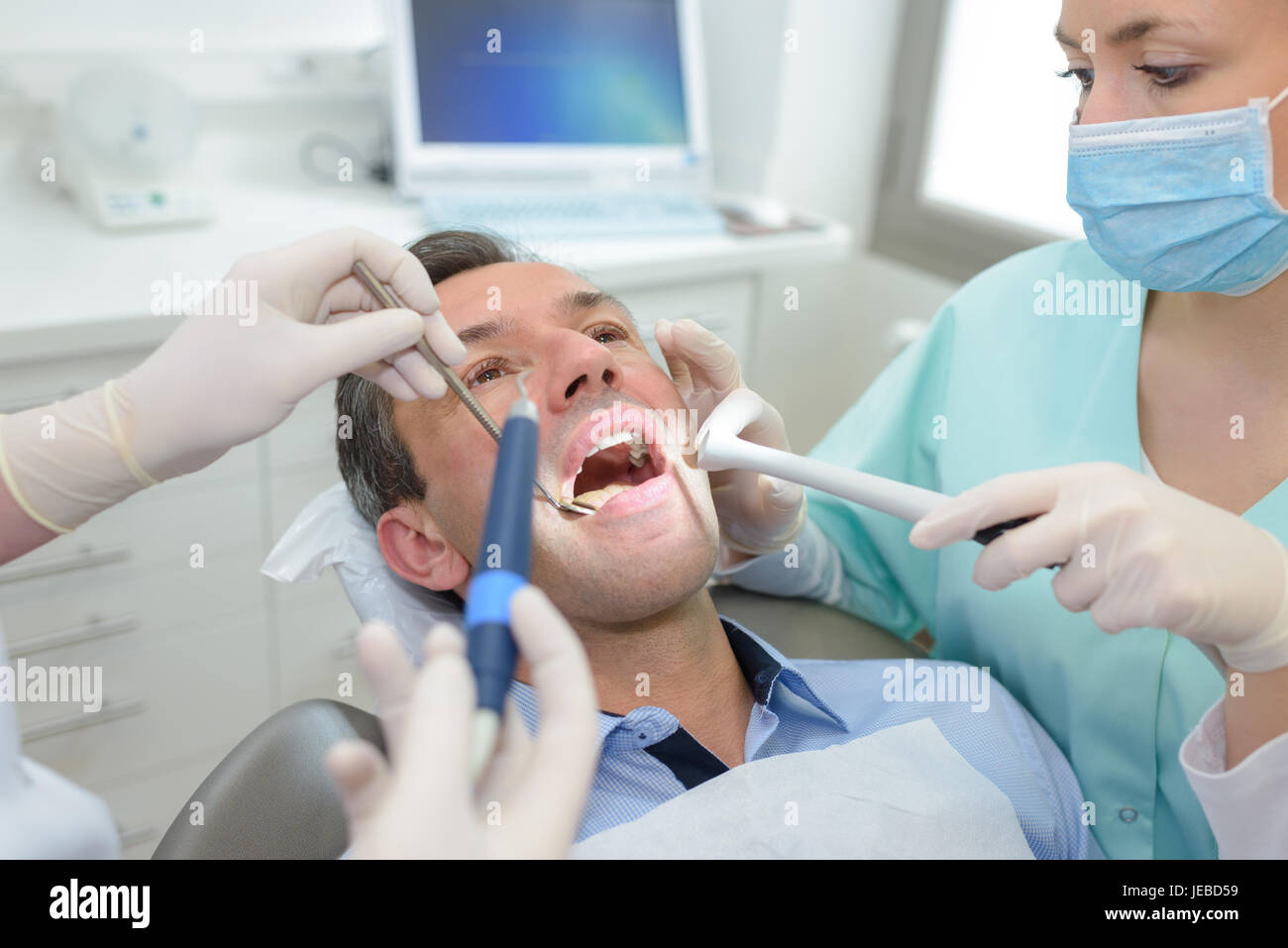 female dentis working with patient at dental clinic office Stock Photo ...