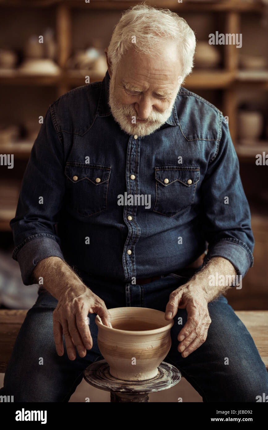 Senior potter making pottery on a wheel at workshop Stock Photo - Alamy
