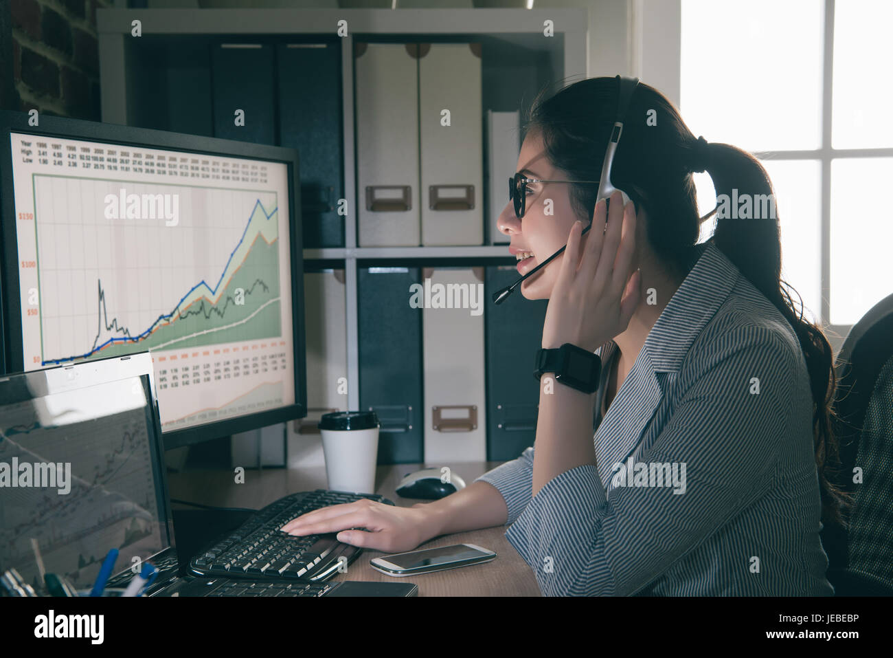 asia stock trader holding microphone talking with client about exchange ...