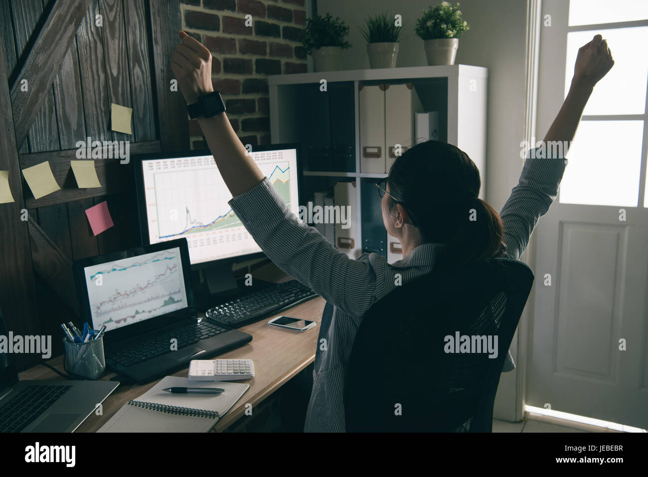 industrious woman enjoying her work on company. stretched arms sitting ...