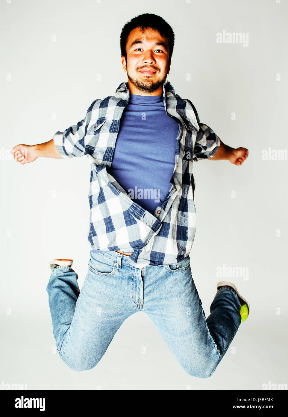 young pretty asian man jumping cheerful against white background Stock ...