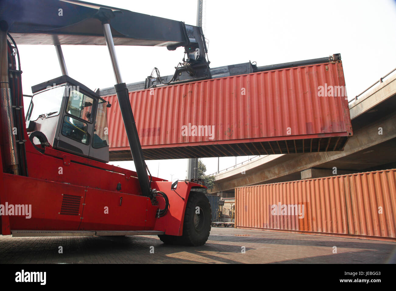 Forklift handling container box lodging at port harbour Stock Photo - Alamy