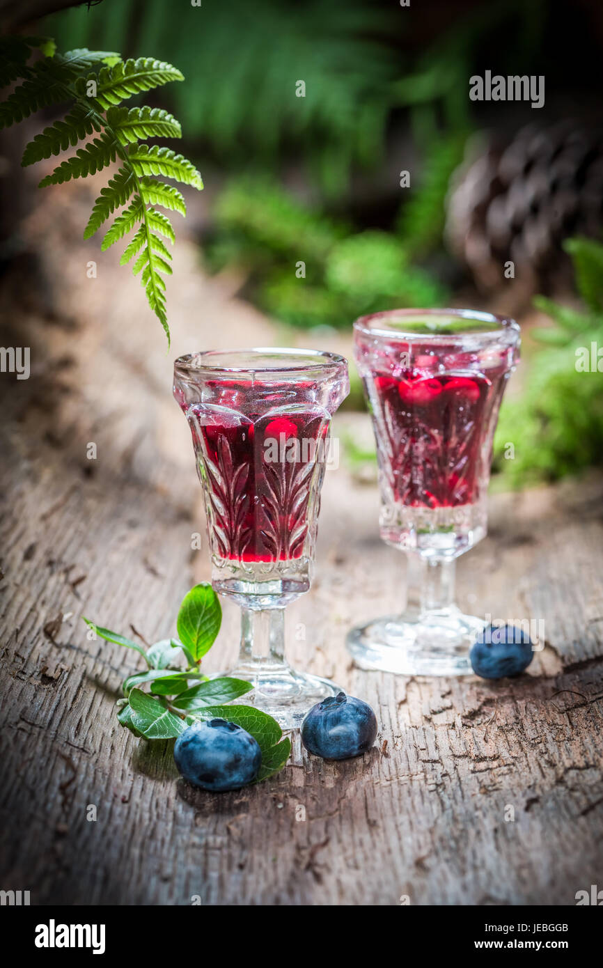 Liqueur made of blueberries and alcohol in forest Stock Photo - Alamy
