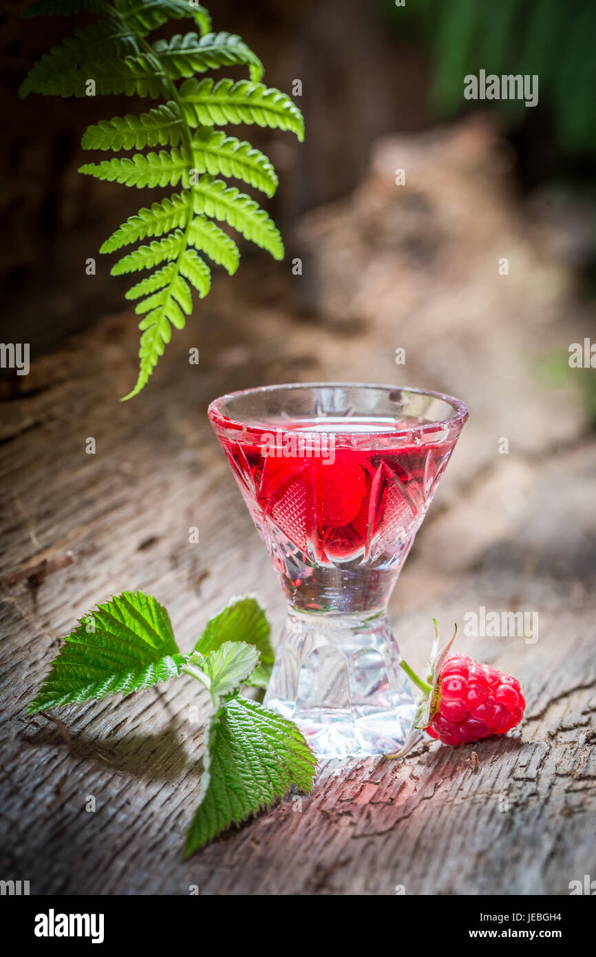 Closeup of sweet raspberries liqueur in forest Stock Photo - Alamy