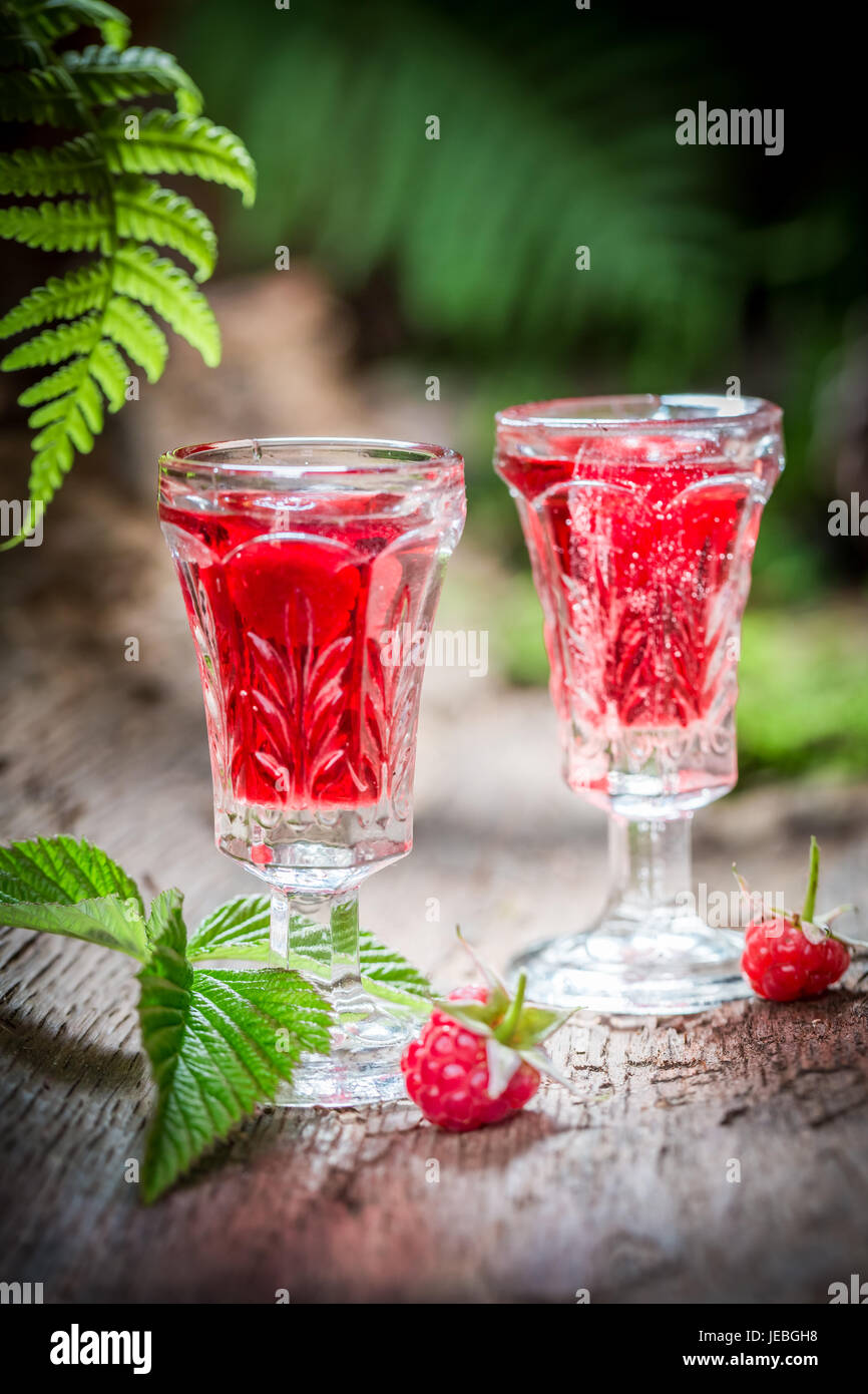 Closeup of raspberries liqueur made of alcohol and fruits Stock Photo ...