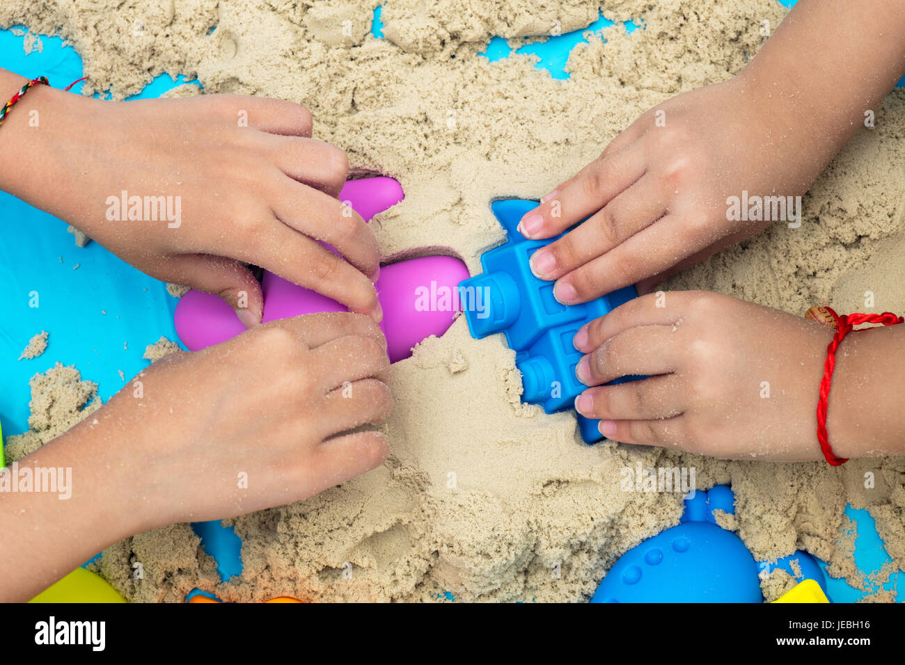 Childs hand close up playing sand at home indoors Stock Photo - Alamy