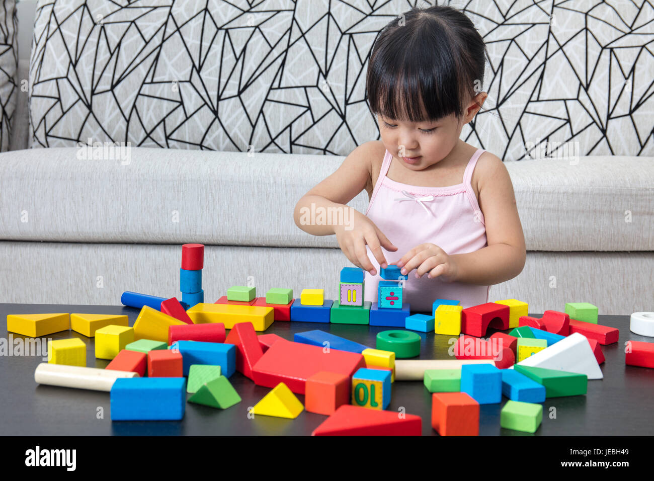 Asian Chinese little girl playing building blocks in the living room at ...