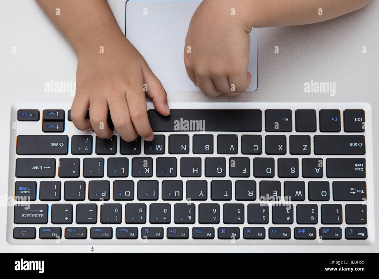 Close up aerial view of children hands typing on laptop keyboard Stock ...