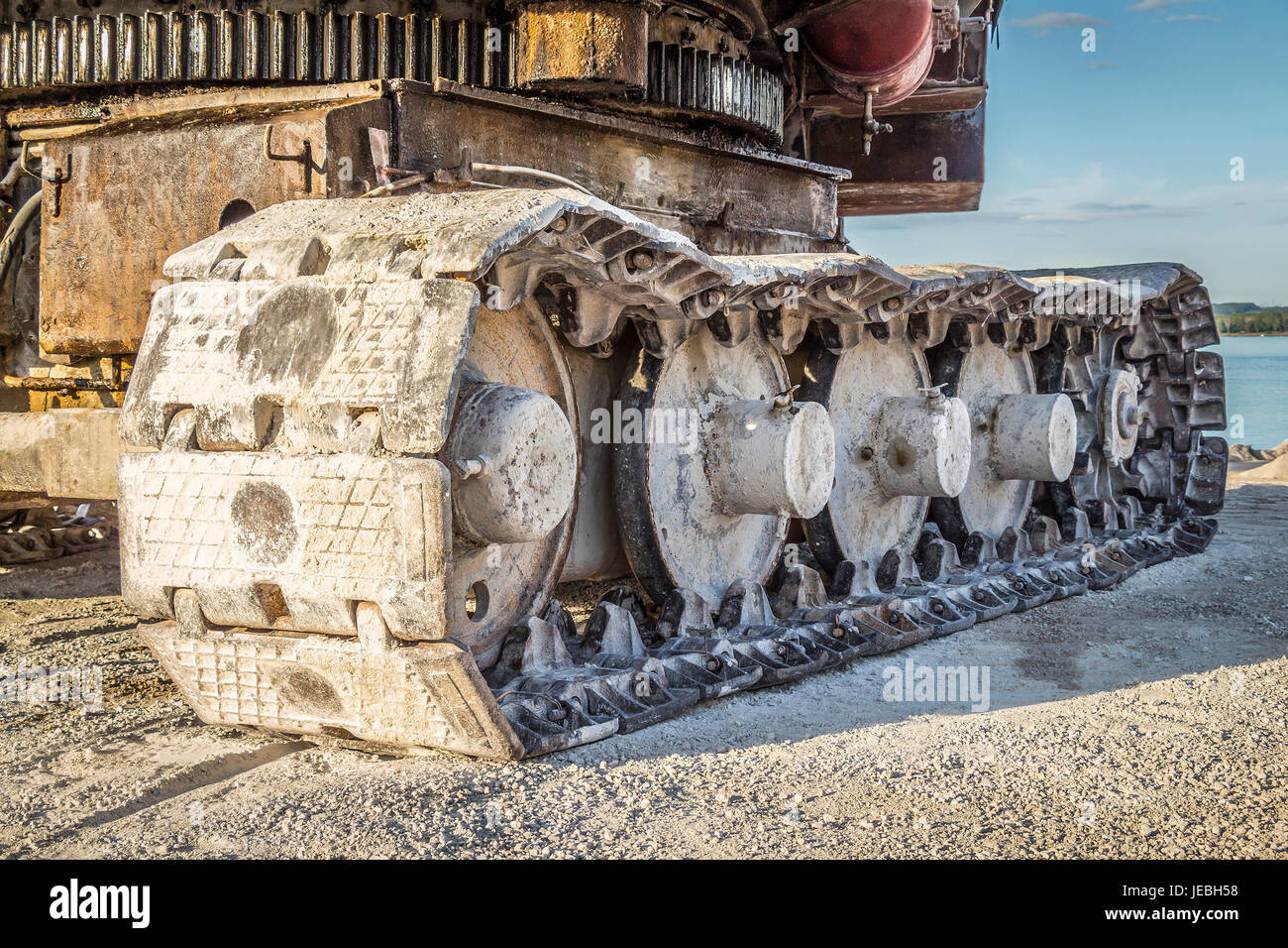 Caterpillar old abandoned quarry excavator close up Stock Photo - Alamy