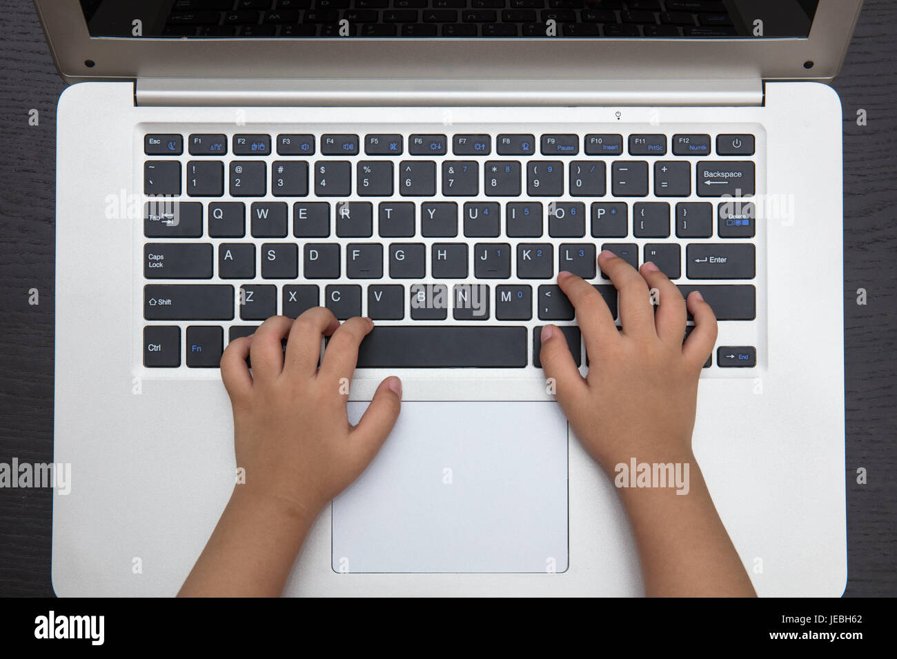 Close up aerial view of children hands typing on laptop keyboard Stock ...