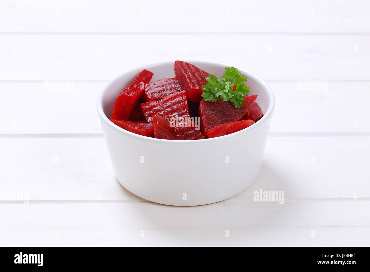 bowl of sliced and pickled beetroot on white wooden background Stock ...