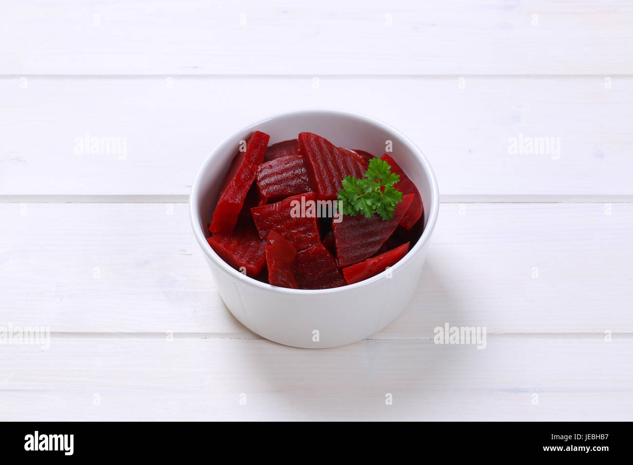 bowl of sliced and pickled beetroot on white wooden background Stock ...