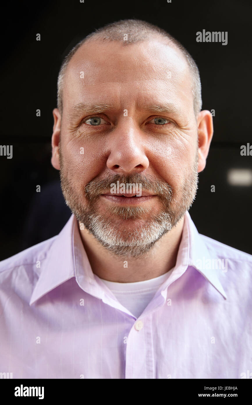 Close-up portrait of middle aged real man in pink shirt Stock Photo - Alamy